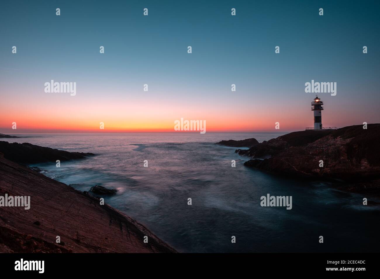 Breathtaking view of beacon standing on coast near amazing sea during ...