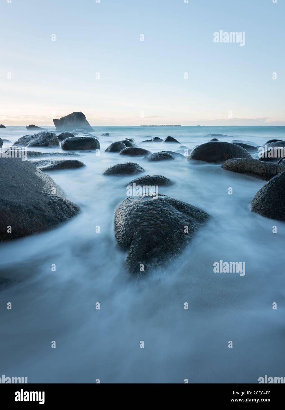 Smooth rocks in flow of water Stock Photo - Alamy