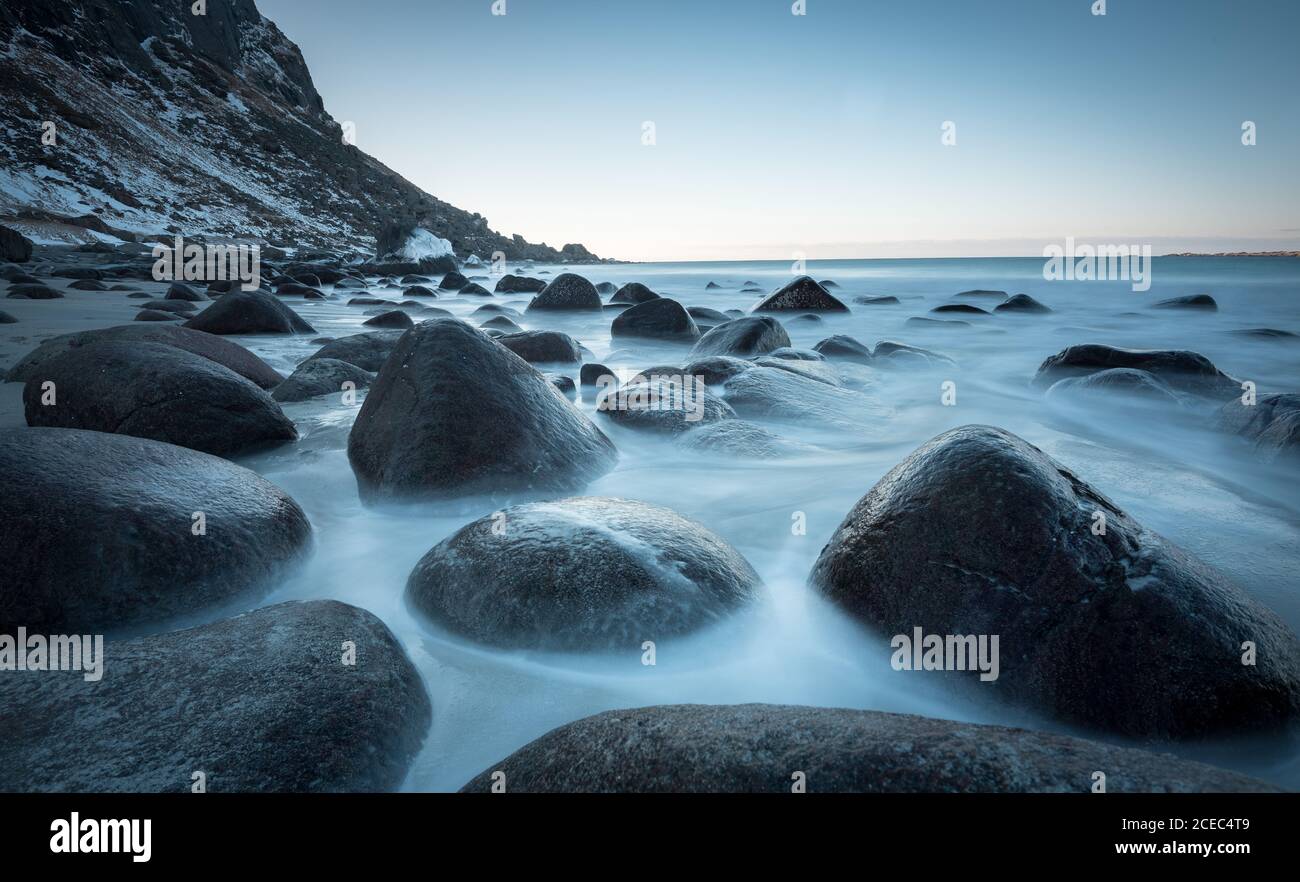 Smooth rocks in flow of water Stock Photo - Alamy