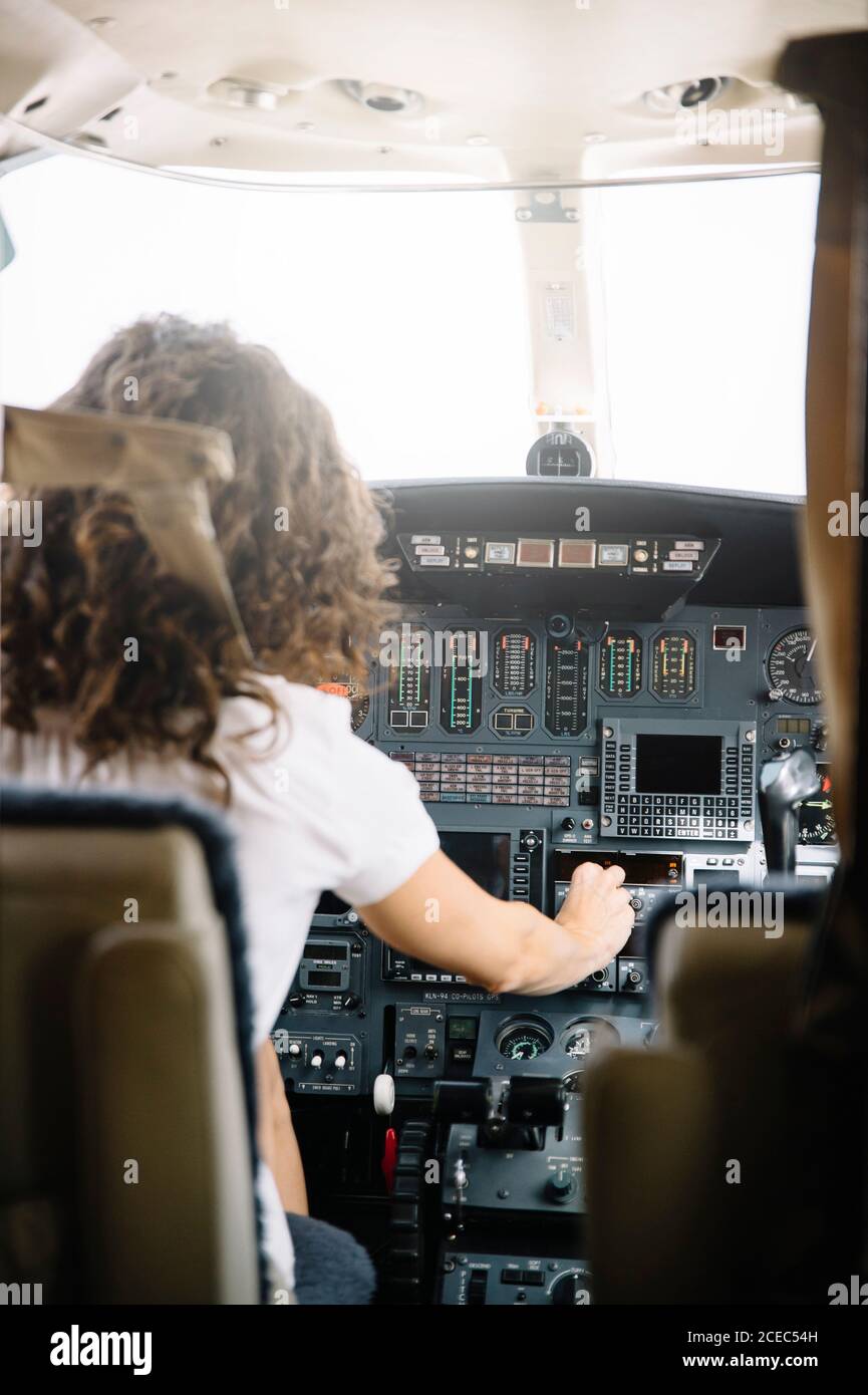Brunette Woman navigating plane Stock Photo - Alamy