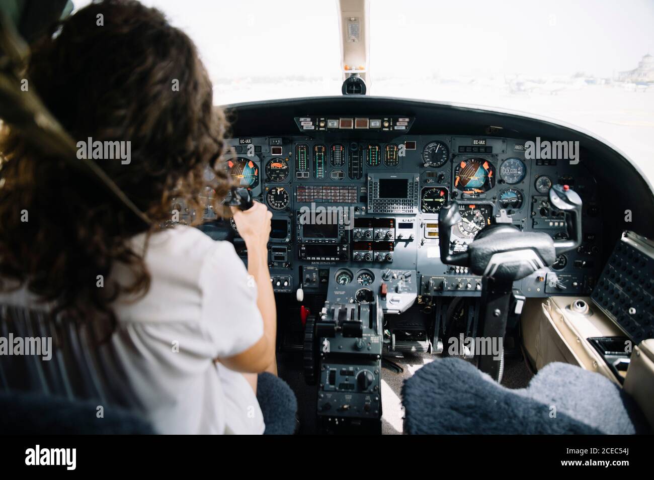 Brunette Woman navigating plane Stock Photo - Alamy