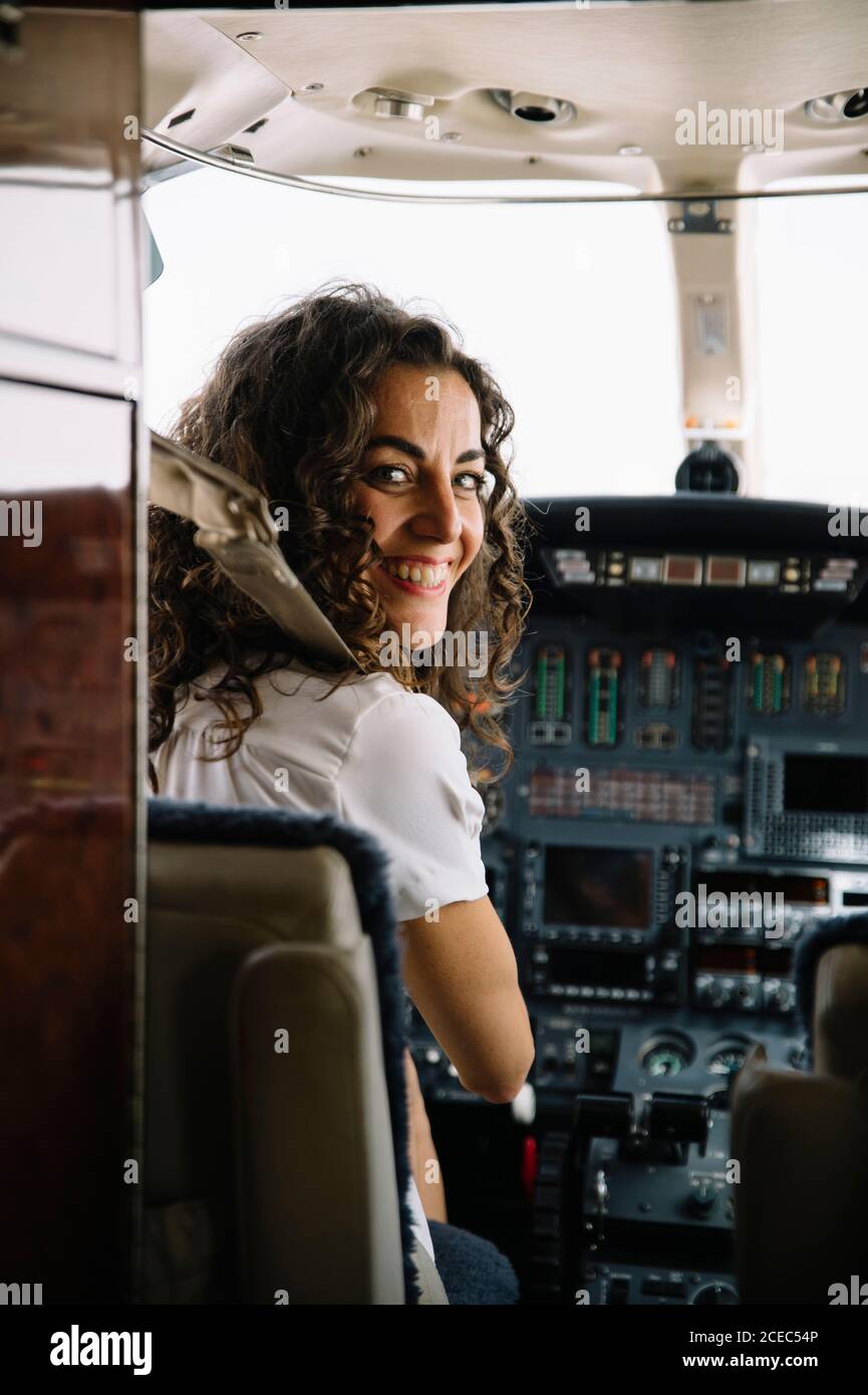 Brunette Woman navigating plane Stock Photo - Alamy