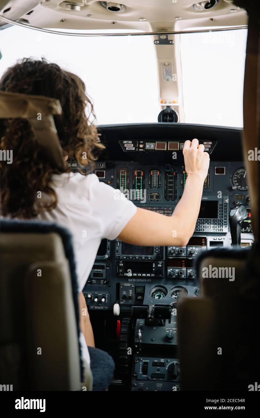Brunette Woman navigating plane Stock Photo - Alamy