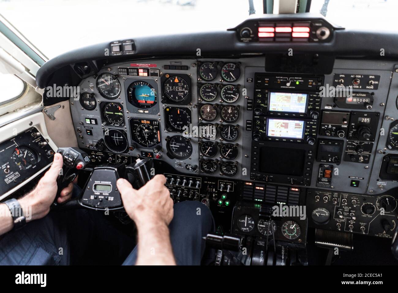 unrecognizable man in headset piloting plane?alone while sitting in ...