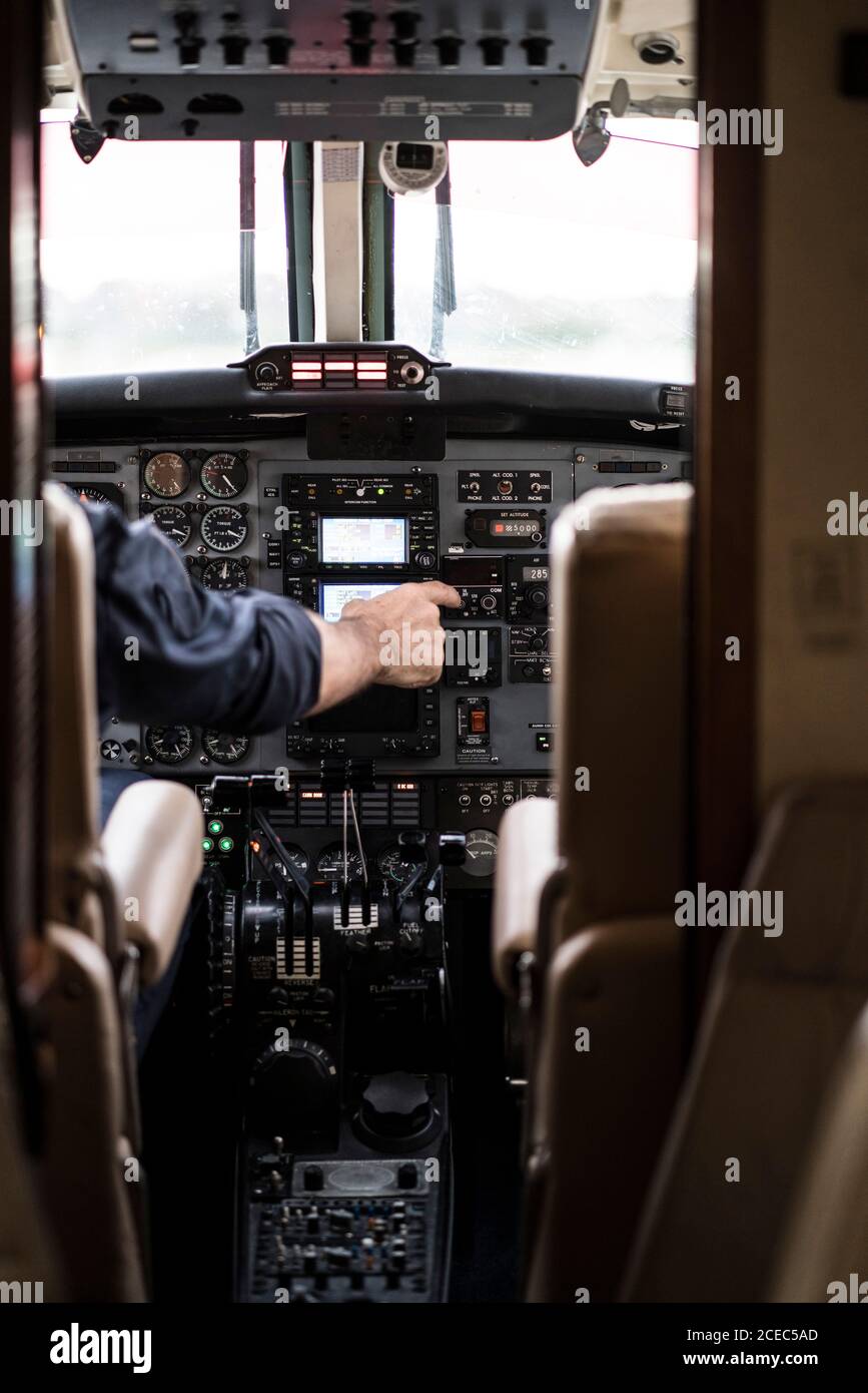unrecognizable man in headset piloting plane?alone while sitting in ...