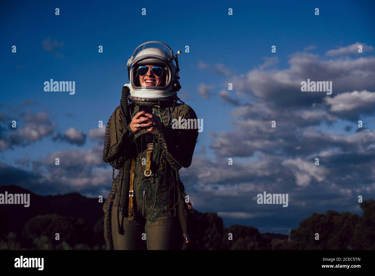 Beautiful female astronaut with mobile phone Stock Photo - Alamy