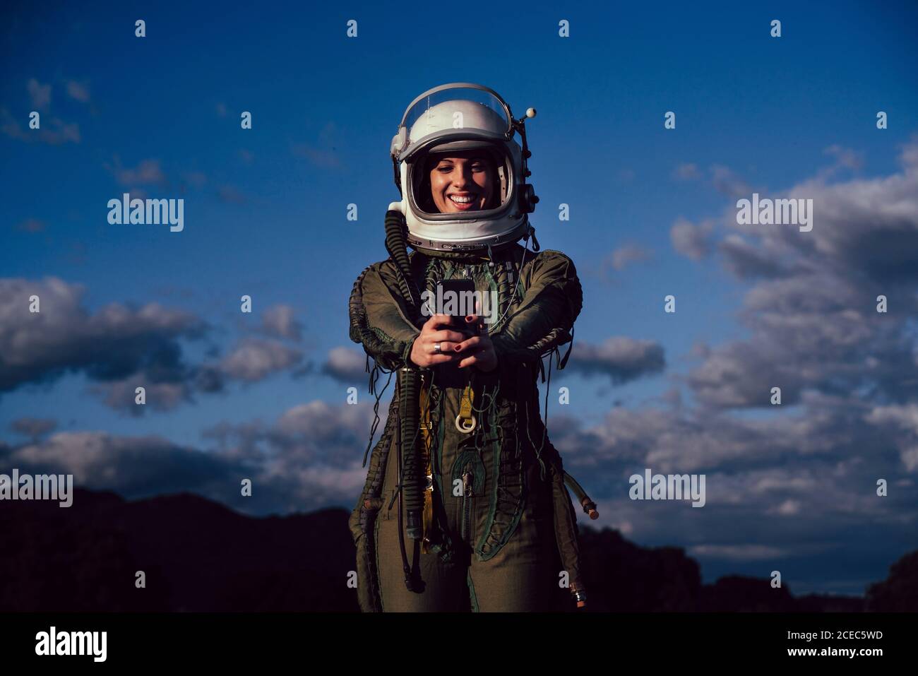 Beautiful female astronaut with mobile phone Stock Photo - Alamy