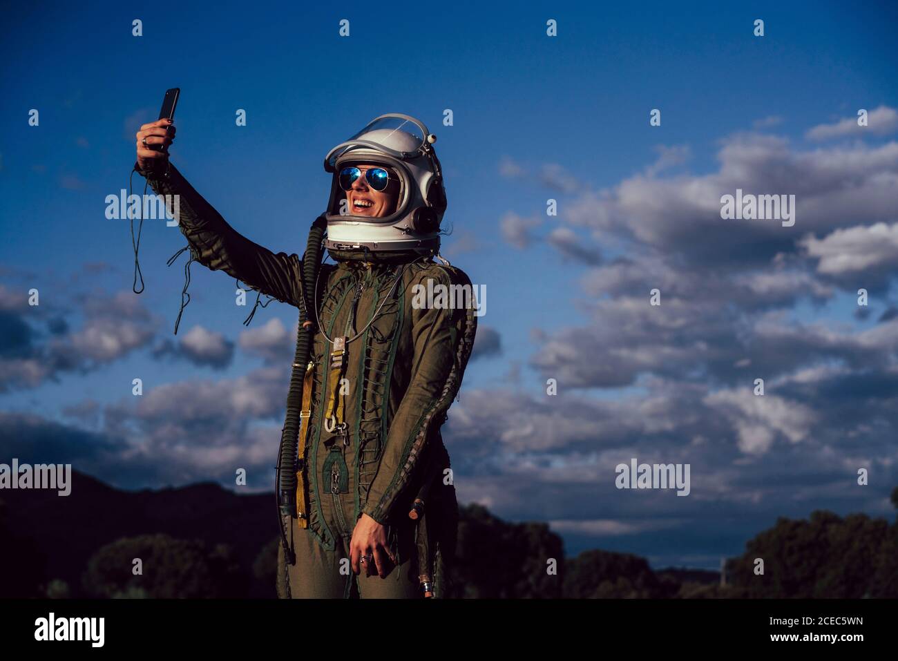 Beautiful female astronaut with mobile phone Stock Photo - Alamy