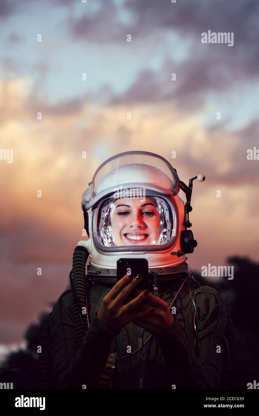 Beautiful female astronaut with mobile phone Stock Photo - Alamy