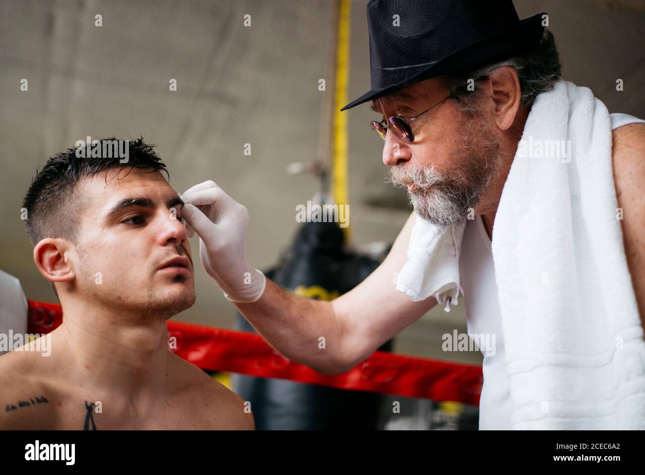 Hands of unrecognizable medic checking the eye of the boxer on boxing ...