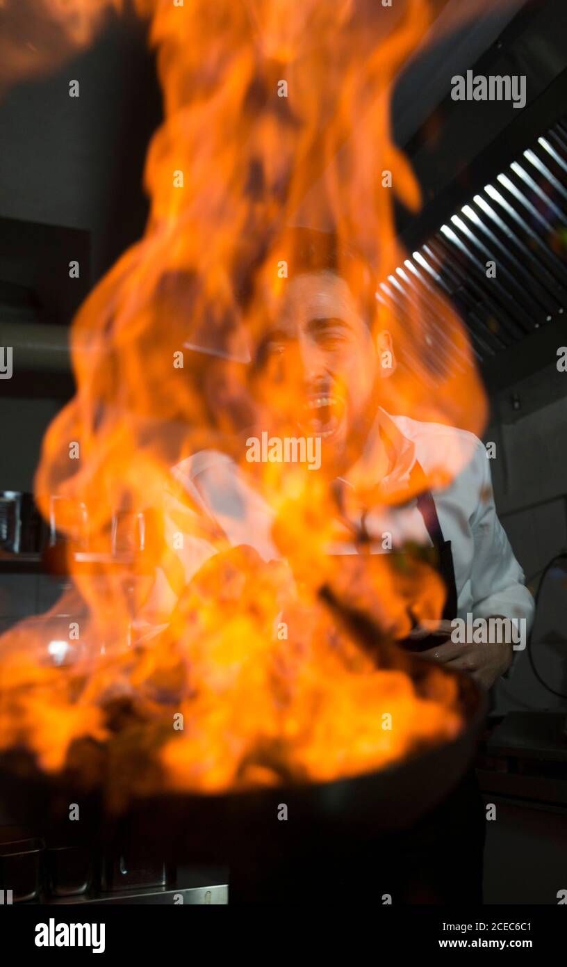 The cook making a flambe Stock Photo - Alamy