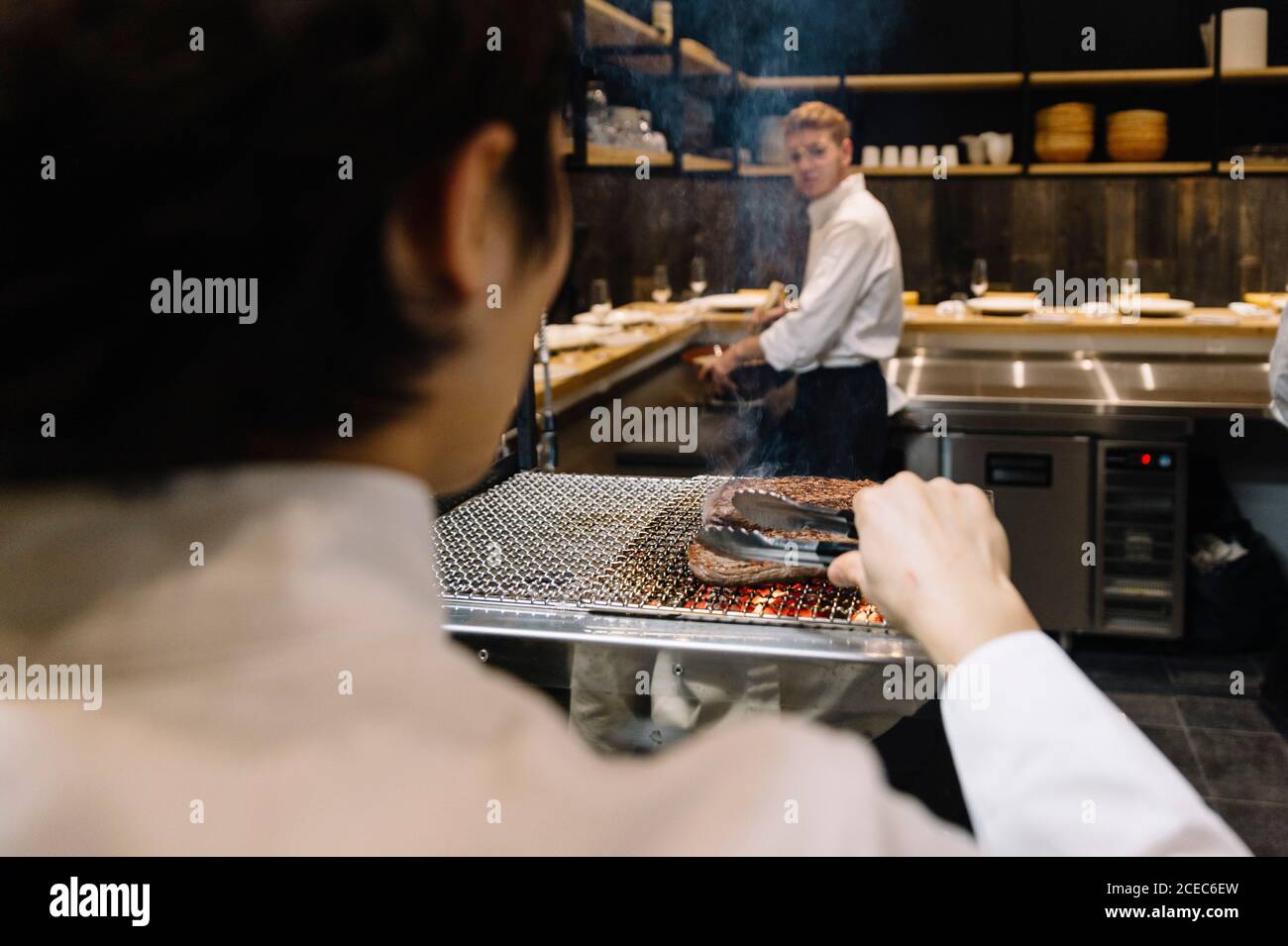 Chef cooking in restaurant preparing beef roast Stock Photo - Alamy