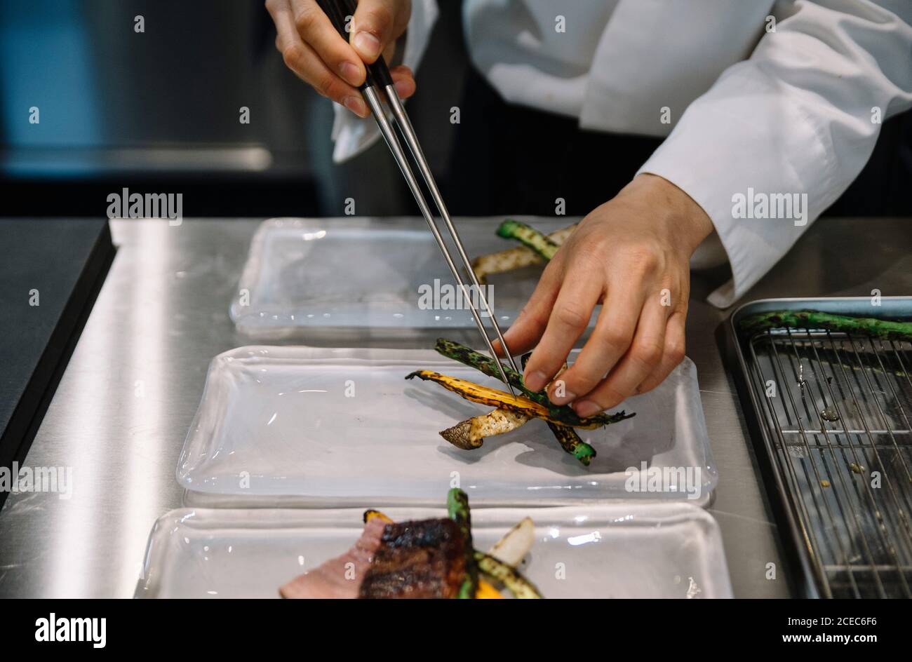Asian man male chef prepares preparing japanese food chopsticks hi-res ...
