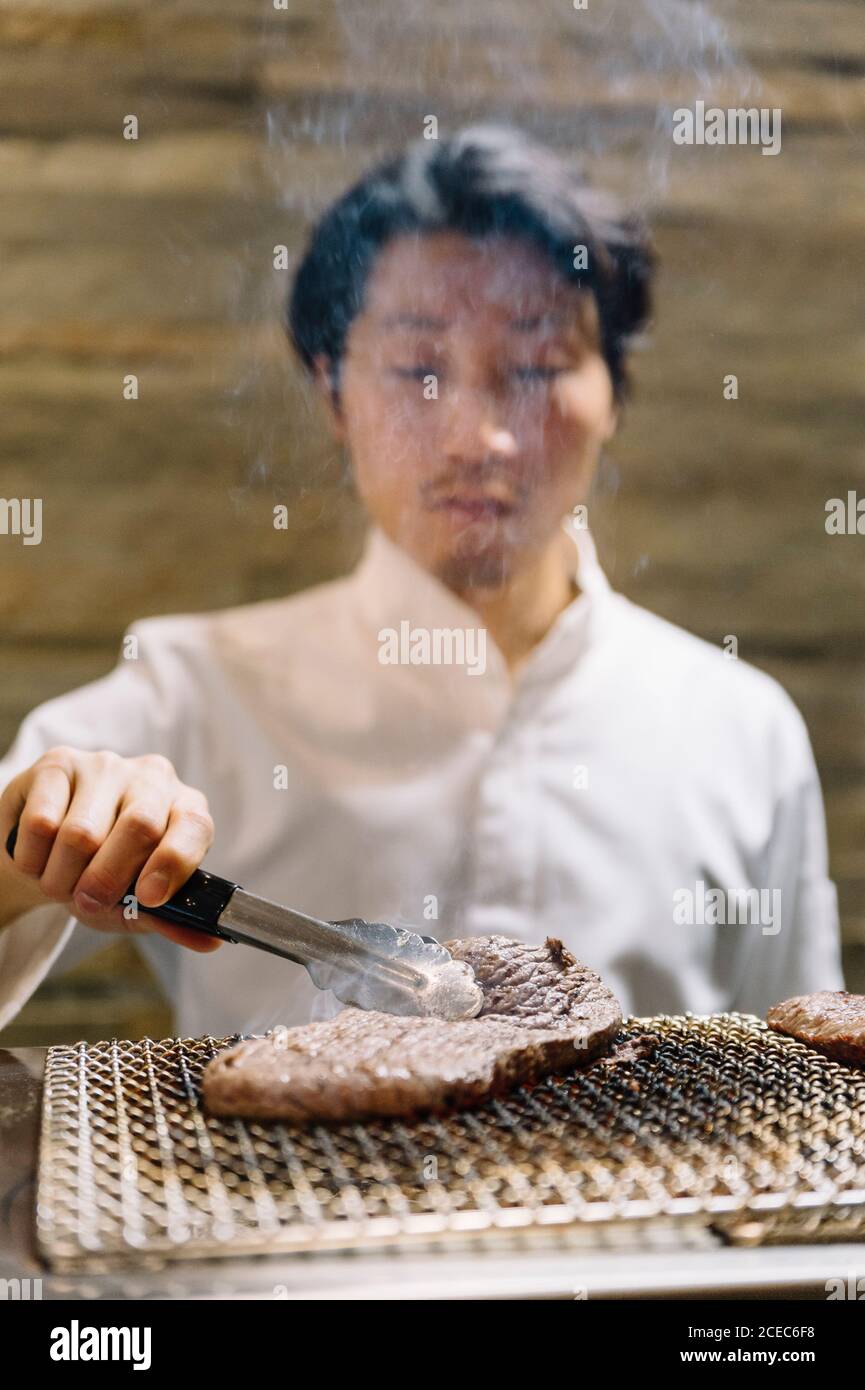 Chef cooking in restaurant preparing beef roast Stock Photo - Alamy