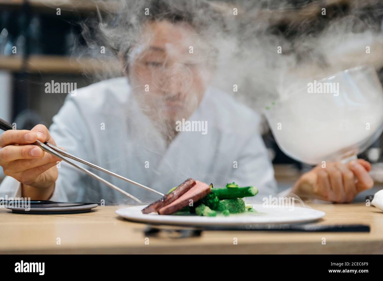 Chef cooking in restaurant with smoke dish Stock Photo - Alamy