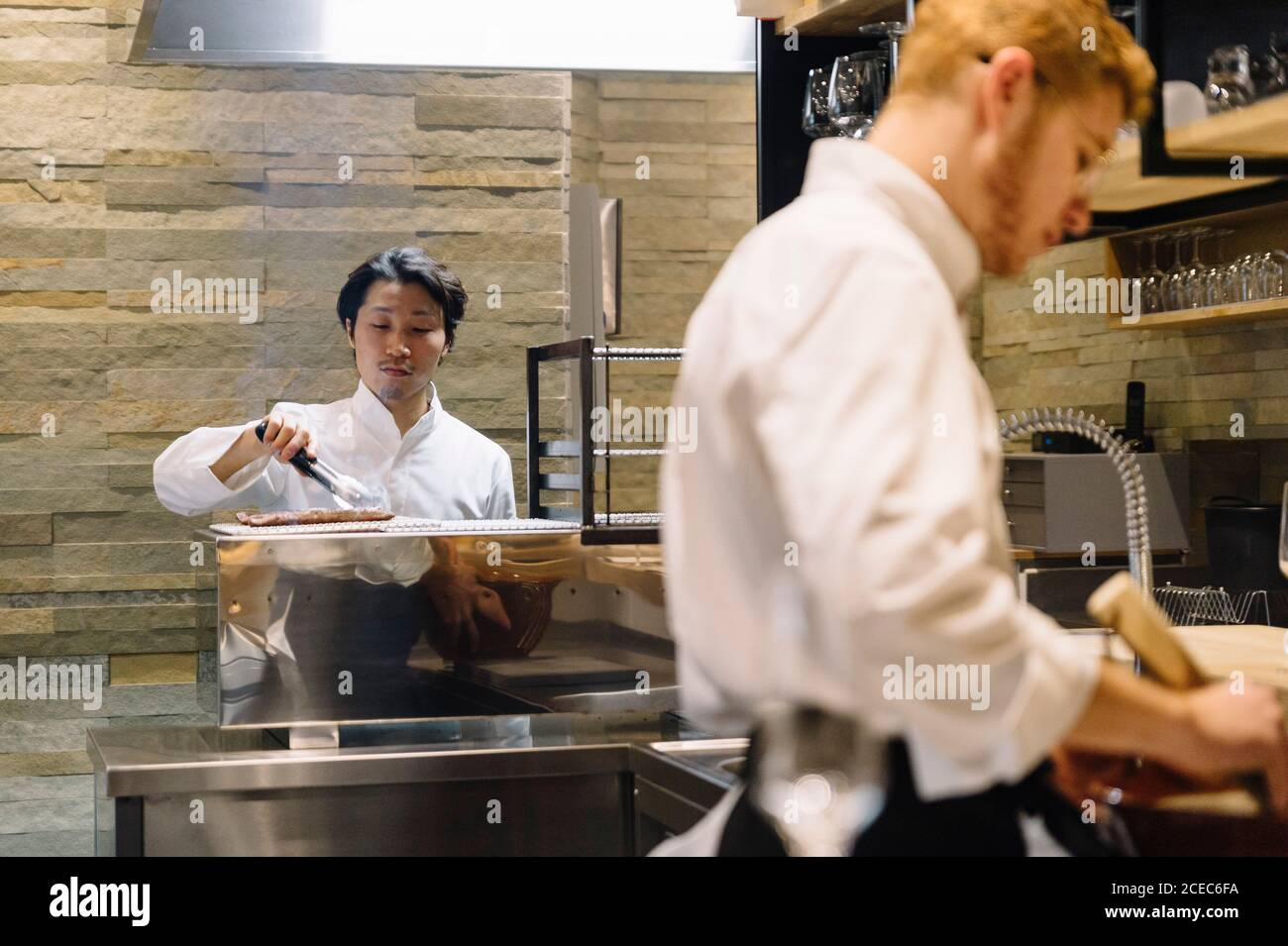 Chef cooking in restaurant preparing beef roast Stock Photo - Alamy