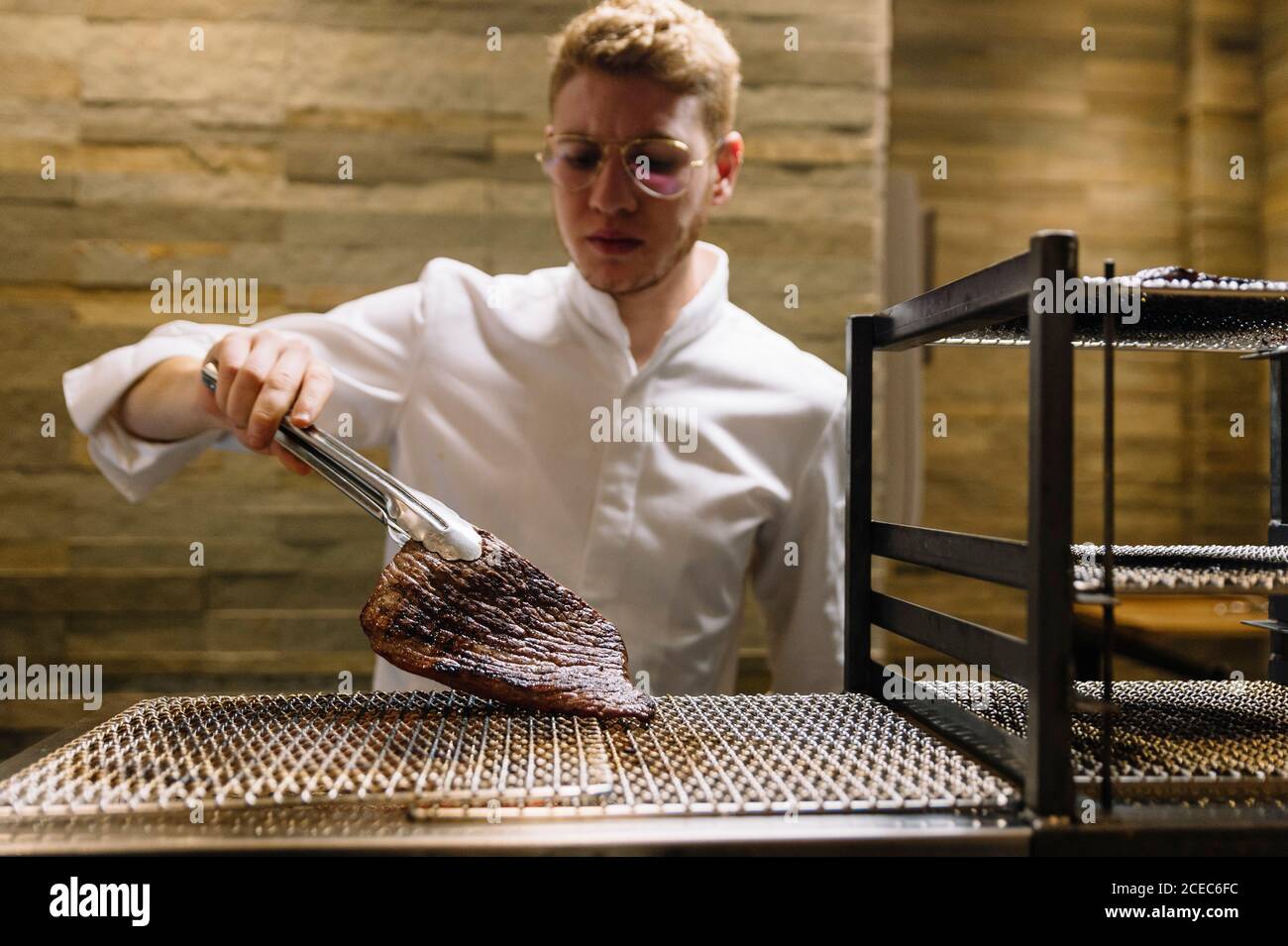 Chef cooking in restaurant preparing beef roast Stock Photo - Alamy