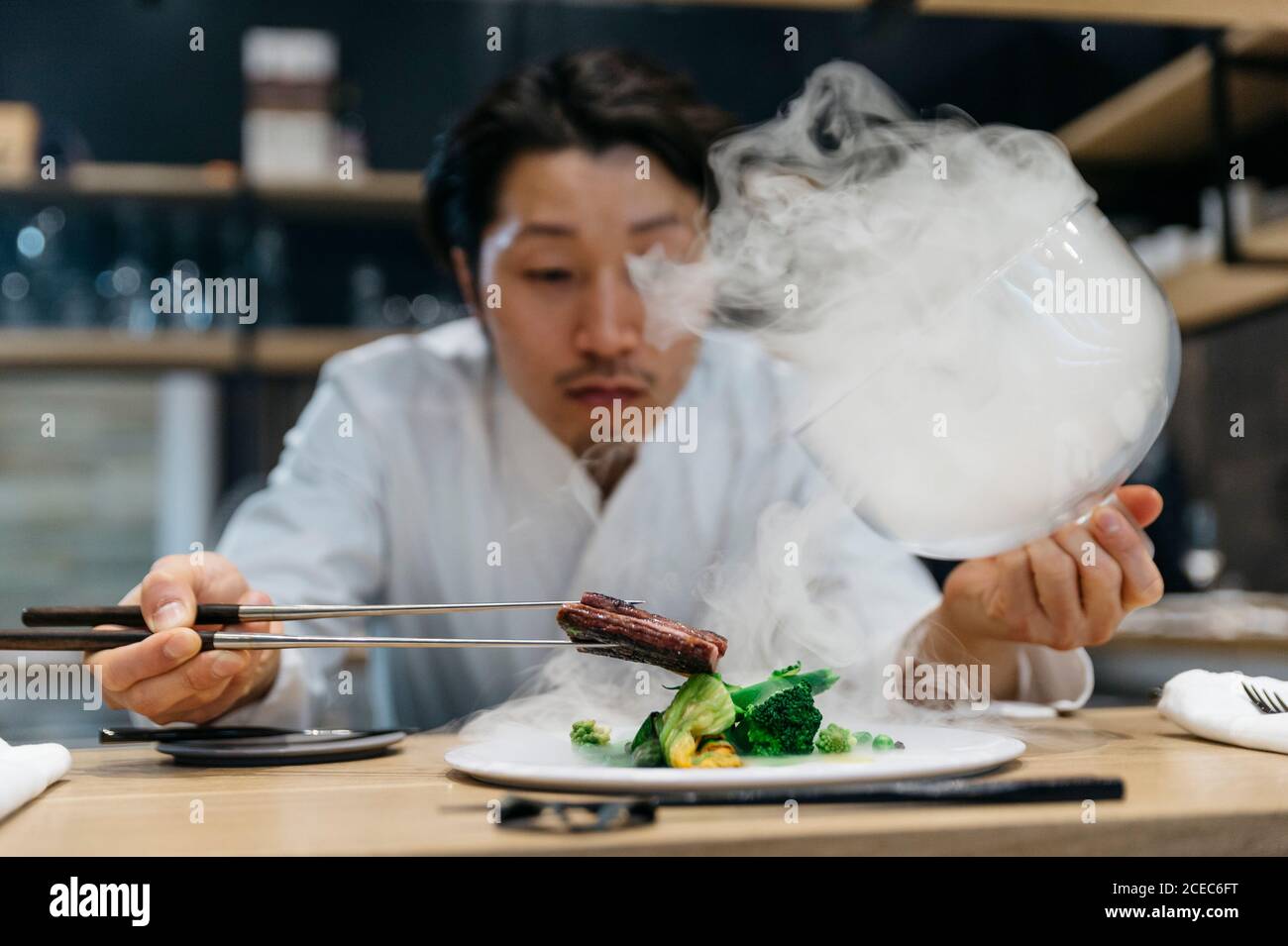 Chef cooking in restaurant with smoke dish Stock Photo - Alamy