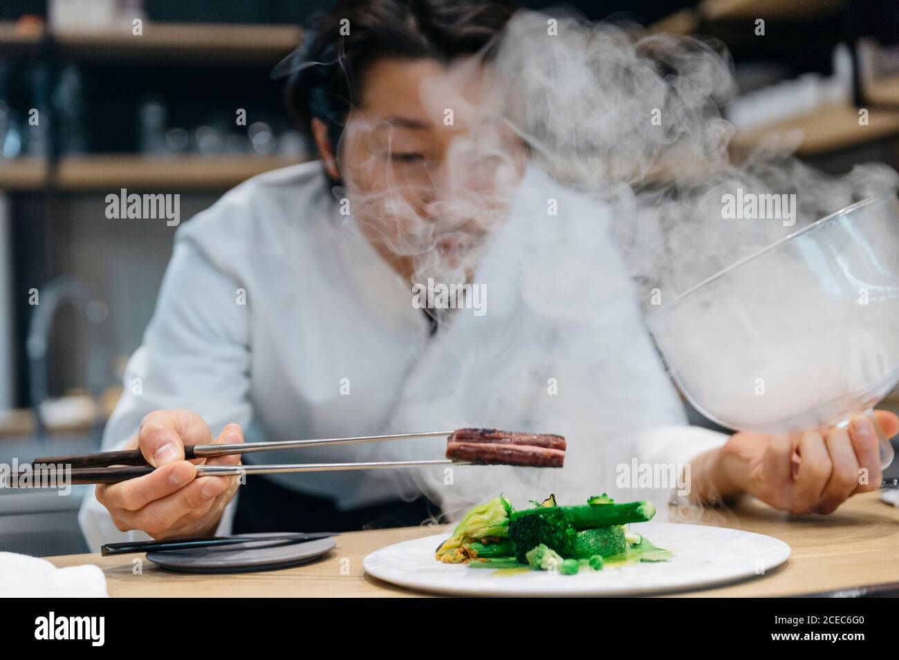 Chef cooking in restaurant with smoke dish Stock Photo - Alamy