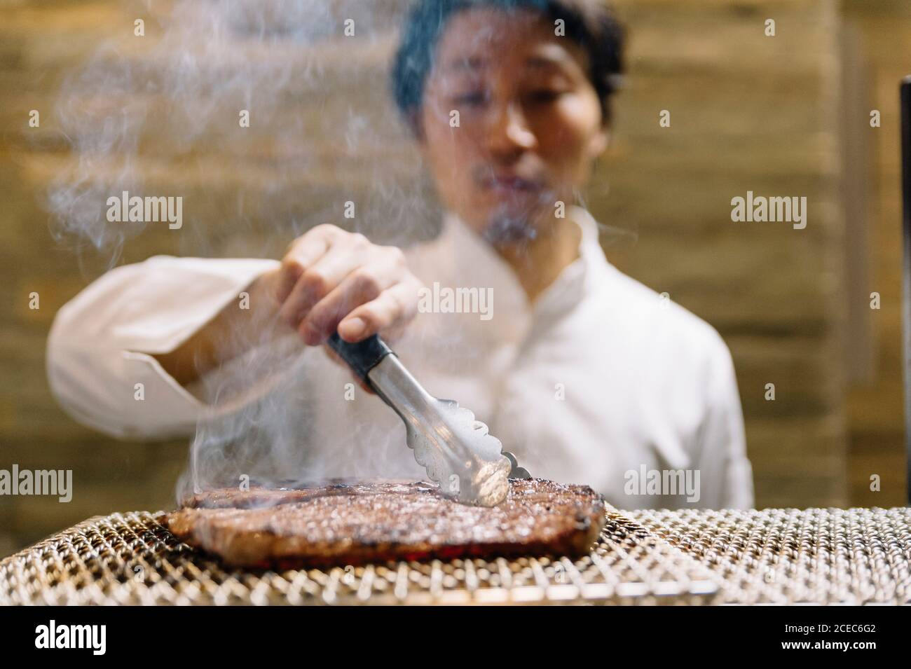 Chef cooking in restaurant preparing beef roast Stock Photo - Alamy