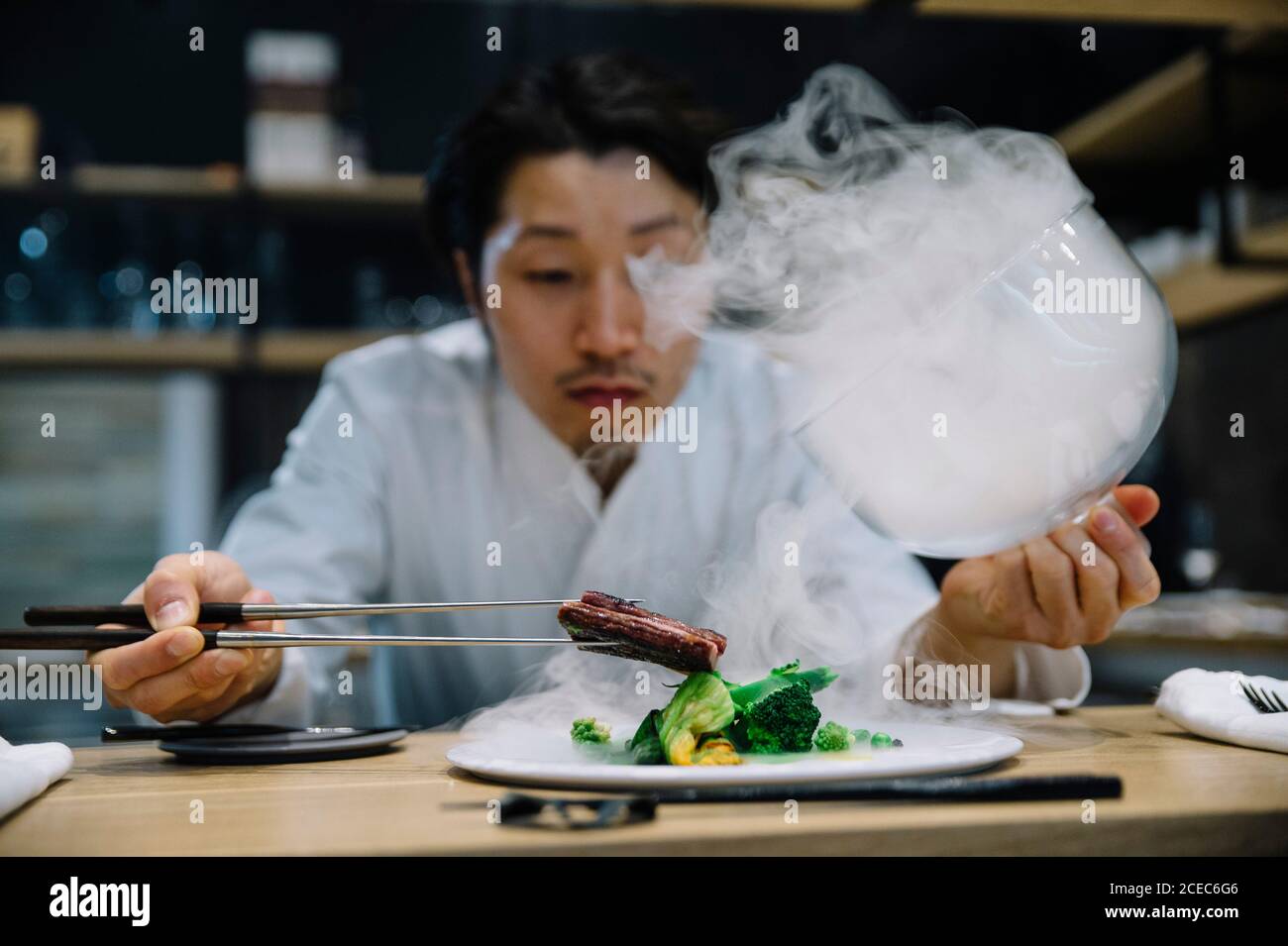 Chef cooking in restaurant with smoke dish Stock Photo - Alamy