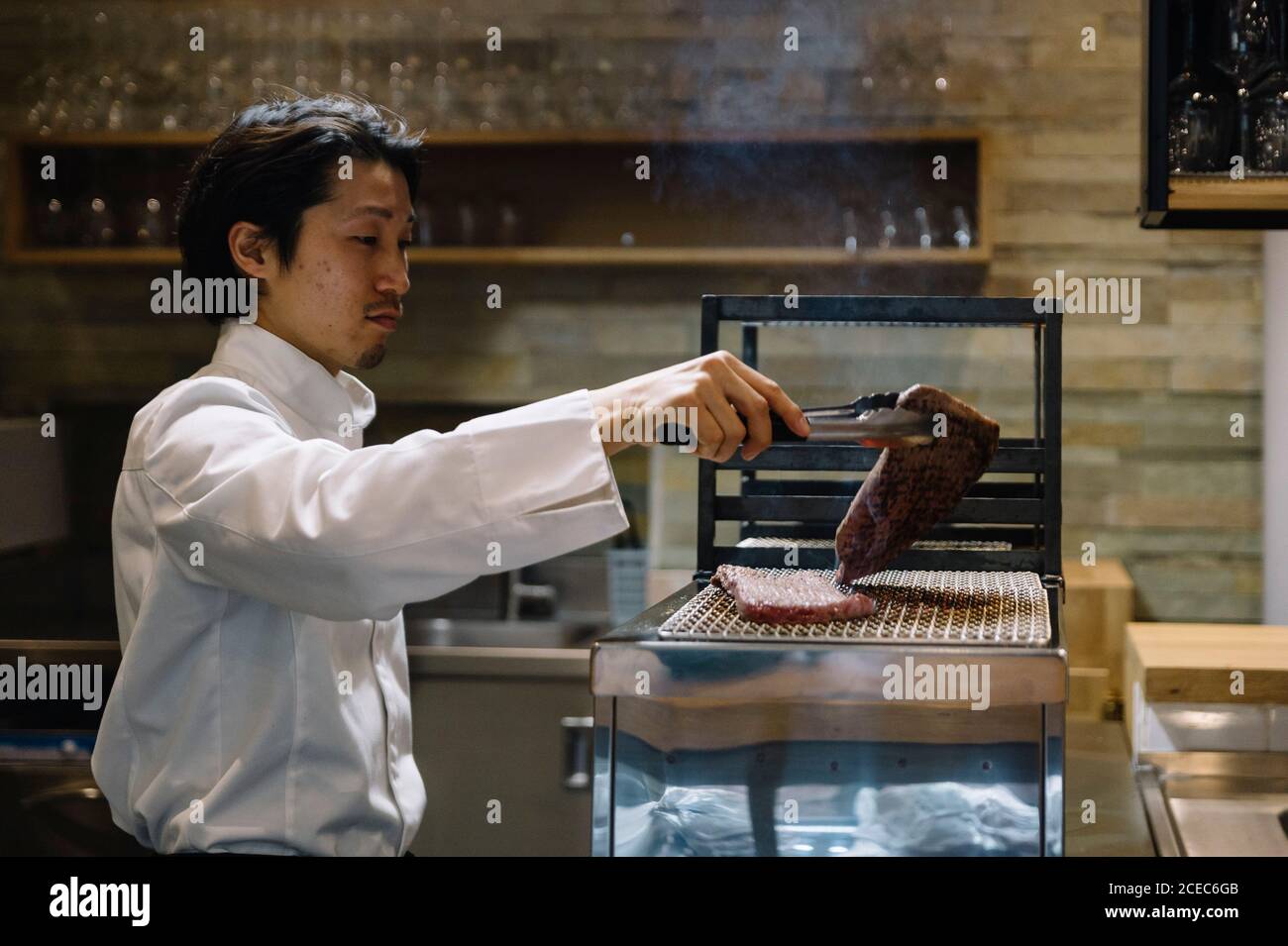 Chef cooking in restaurant preparing beef roast Stock Photo - Alamy