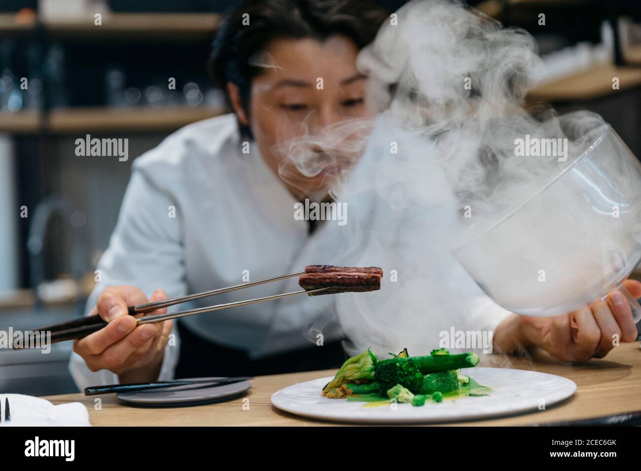 Chef cooking in restaurant with smoke dish Stock Photo - Alamy