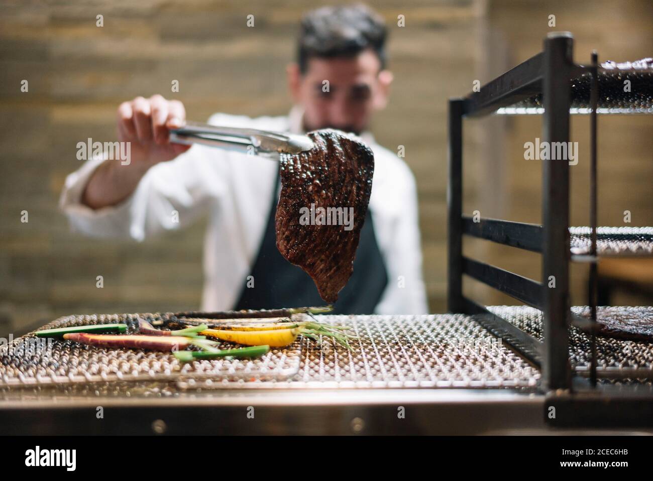 Chef cooking in restaurant preparing beef roast Stock Photo - Alamy