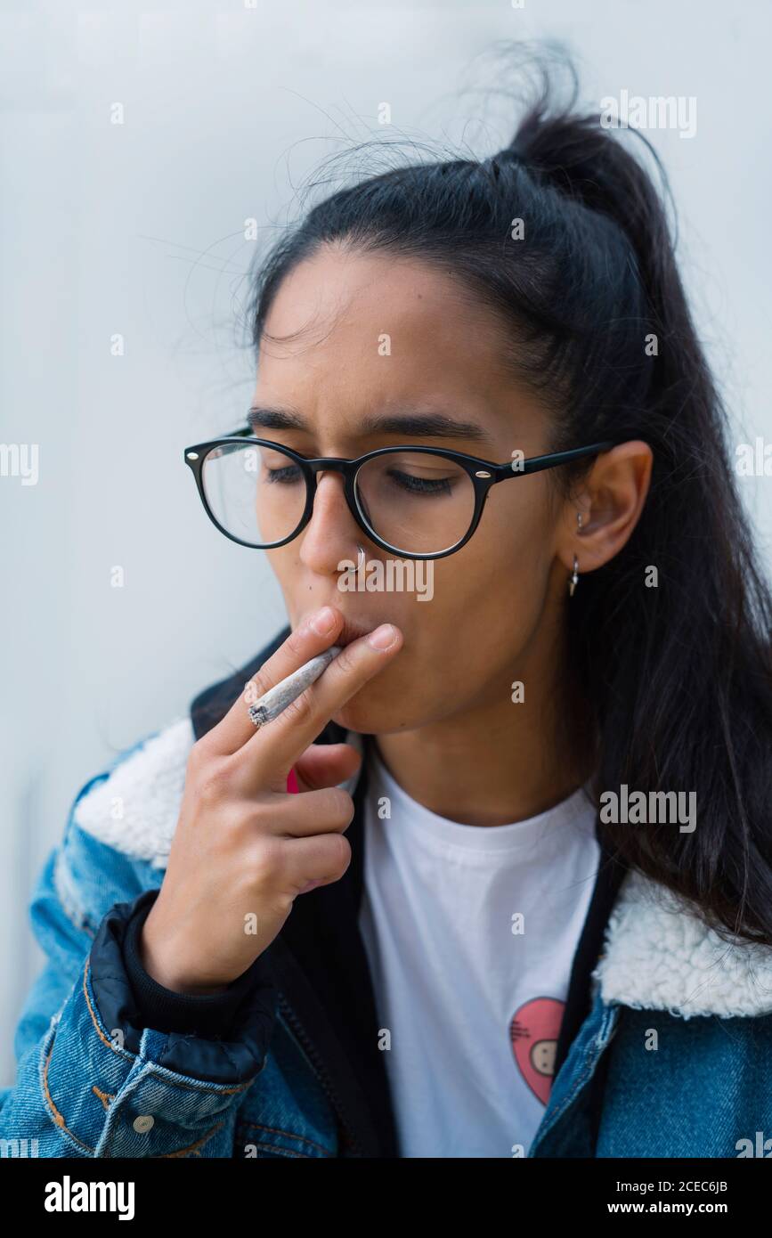 Beautiful young woman lighting cigarette hi-res stock photography and ...