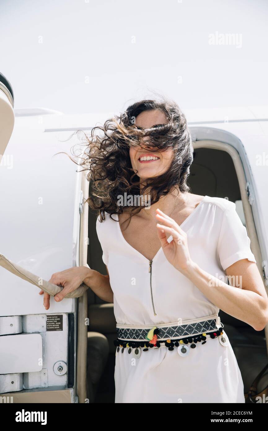 Young Woman passenger departing from the plane on arrival at the ...