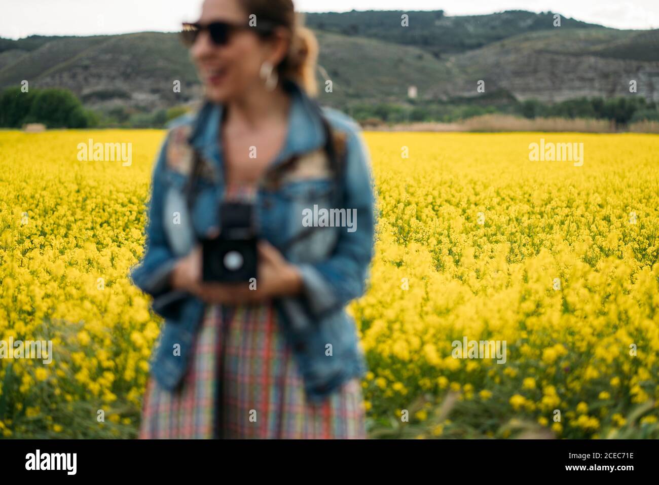 Lady in casual and sunglasses laughing in nature warm and bright colors ...