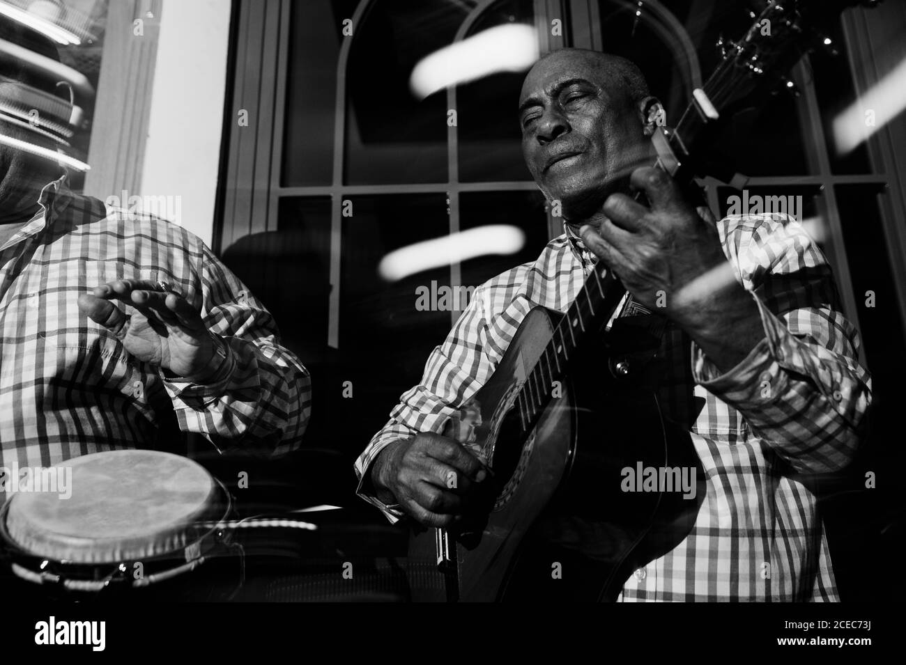 Cuban musical trio acting in the night club Stock Photo - Alamy