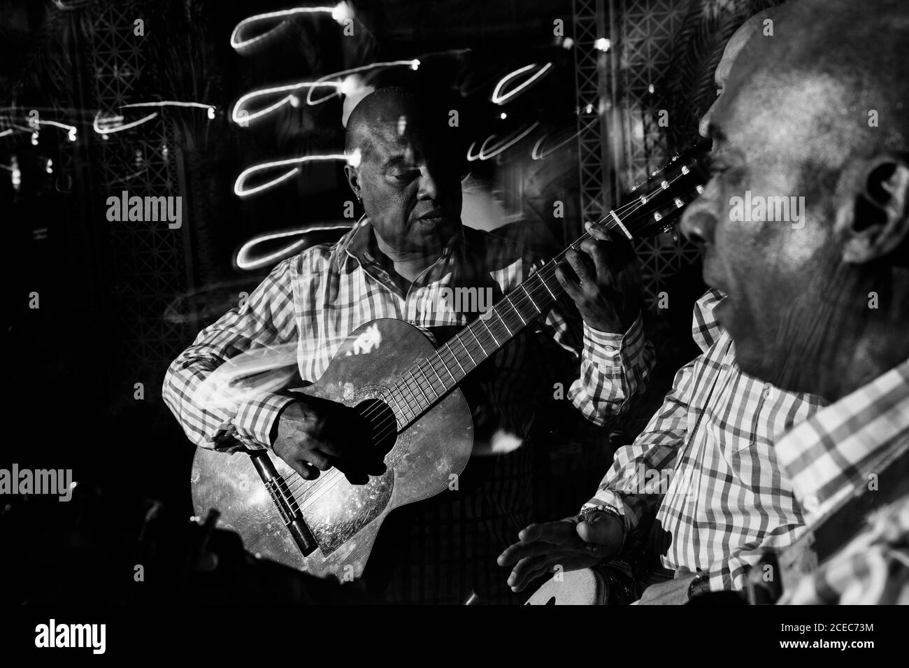 Cuban musical trio acting in the night club Stock Photo - Alamy