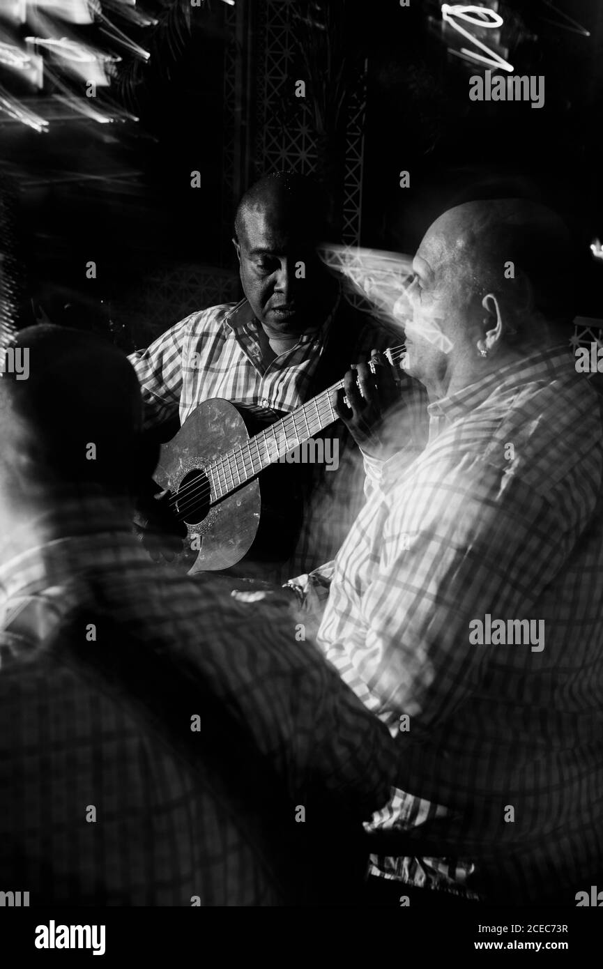 Cuban musical trio acting in the night club Stock Photo - Alamy