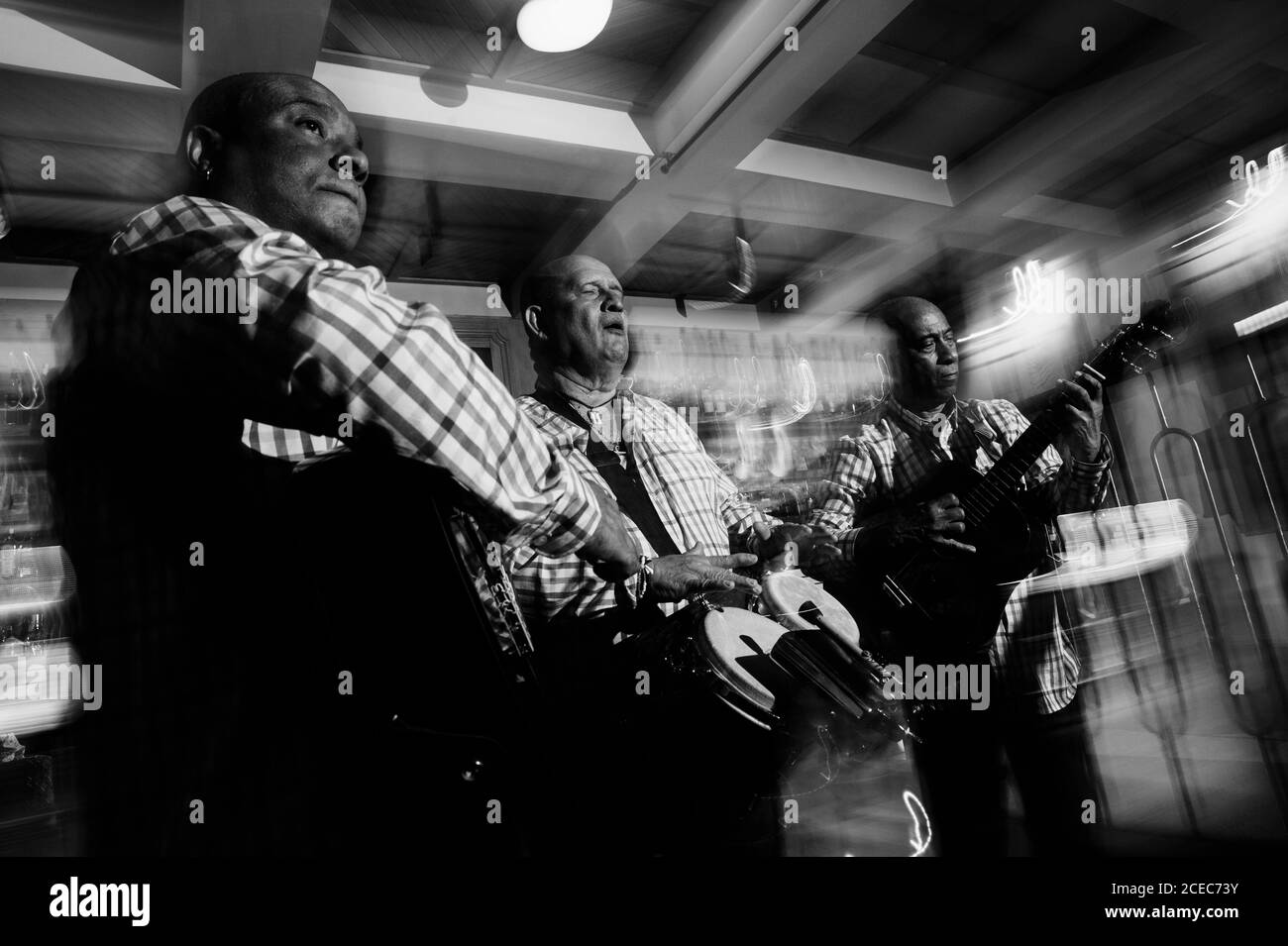 Cuban musical trio acting in the night club Stock Photo - Alamy