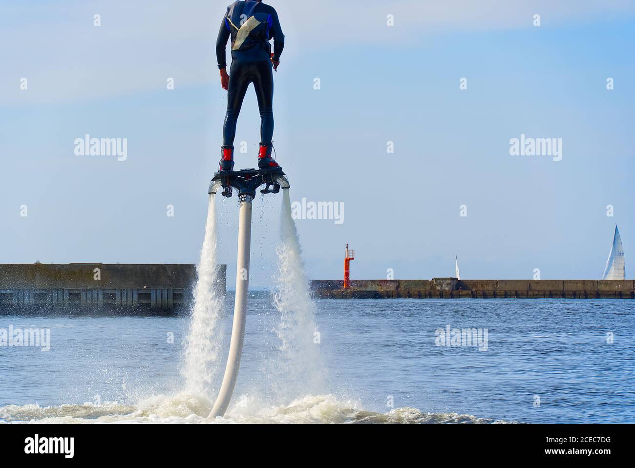 man having fun on Flyboard. Flyboarding in a sunny summer day at river ...