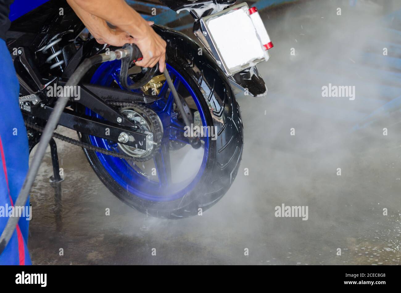 High-pressure water gun washing a motorcycle Stock Photo - Alamy