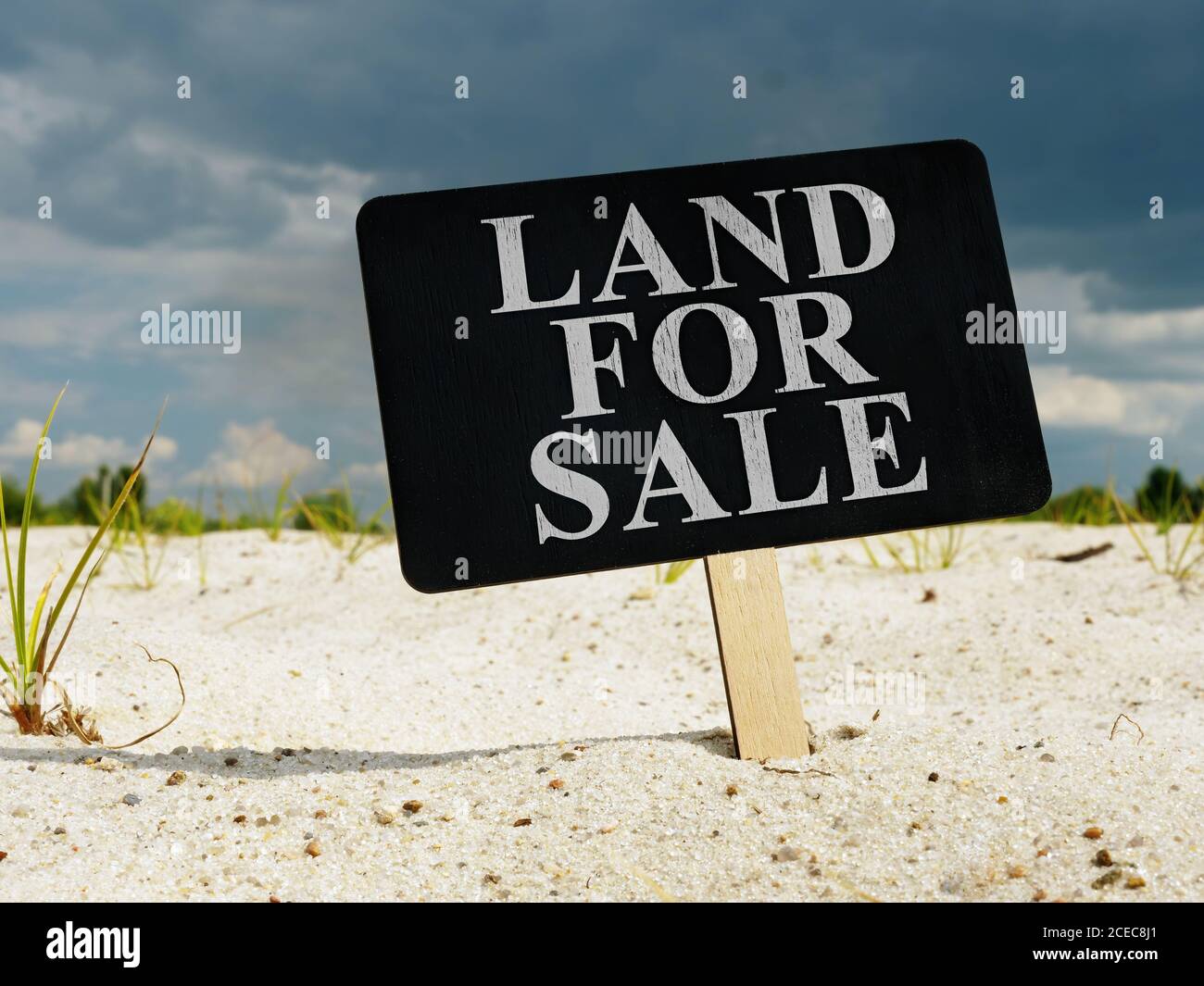 Land for sale. The sign is stuck in the ground Stock Photo - Alamy