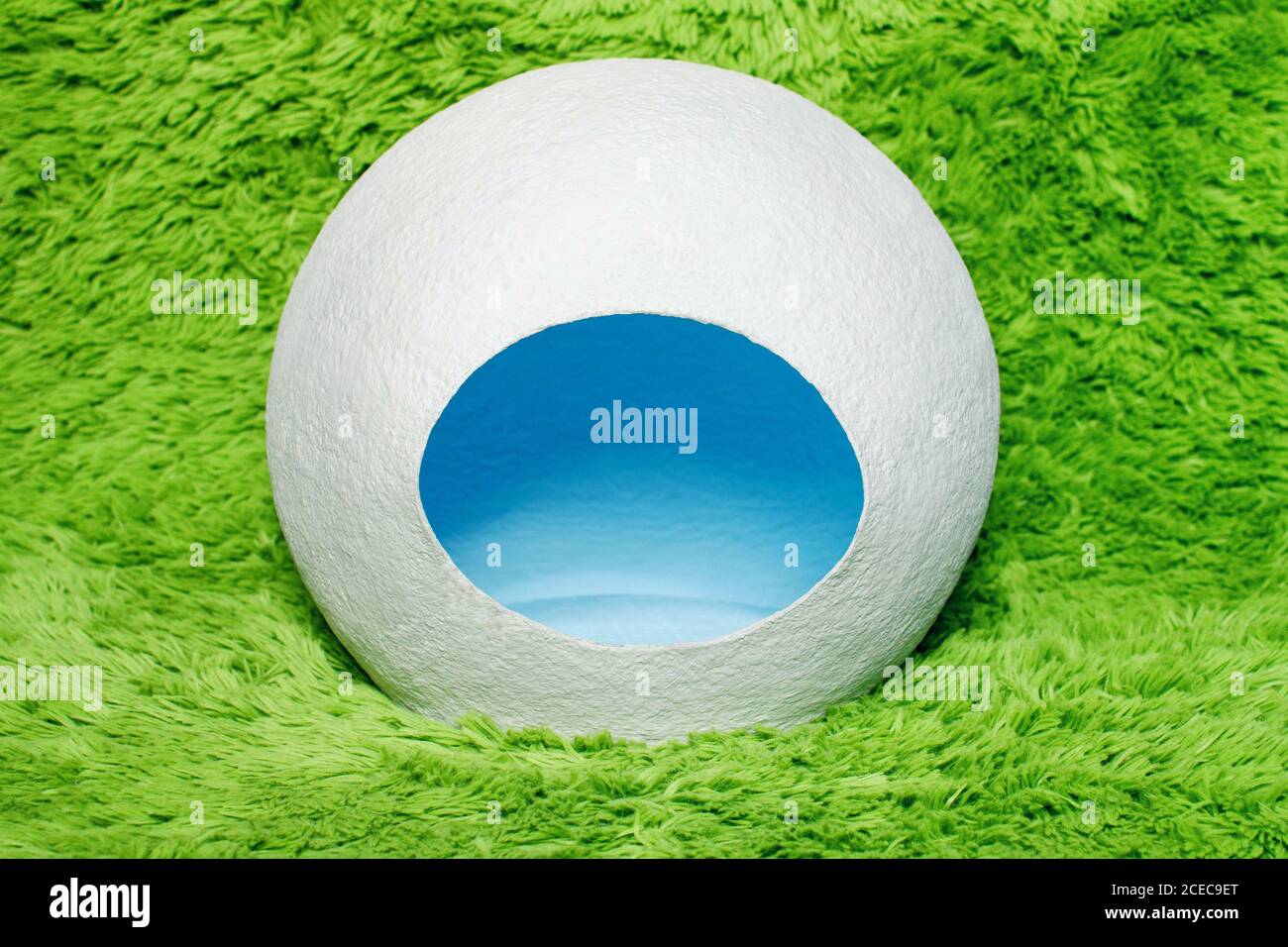 Handmade white sphere house on green background. House made from papier ...