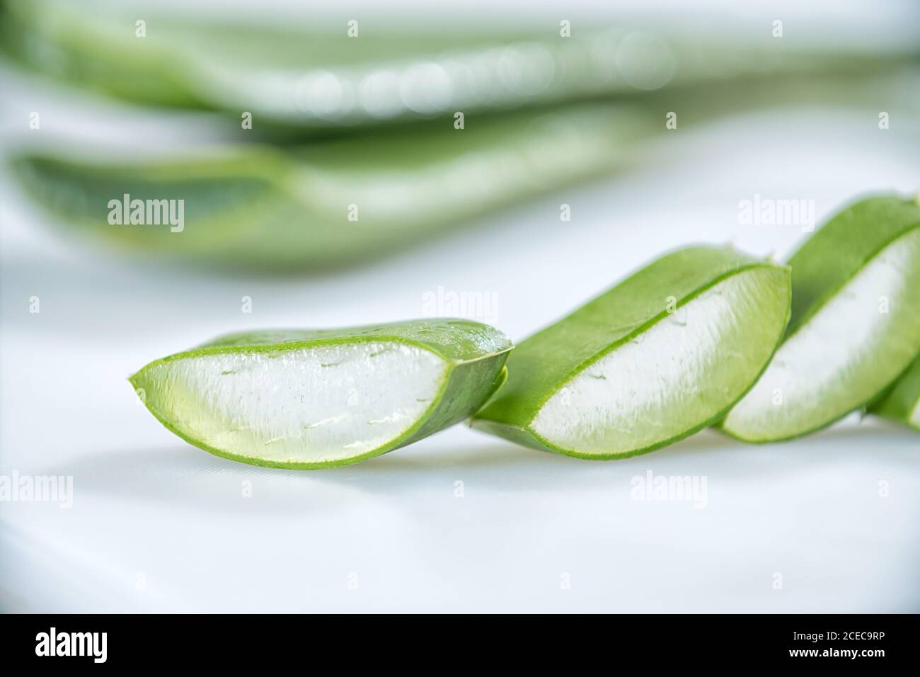 Pieces of fresh green Aloe Vera with white flesh on light background ...