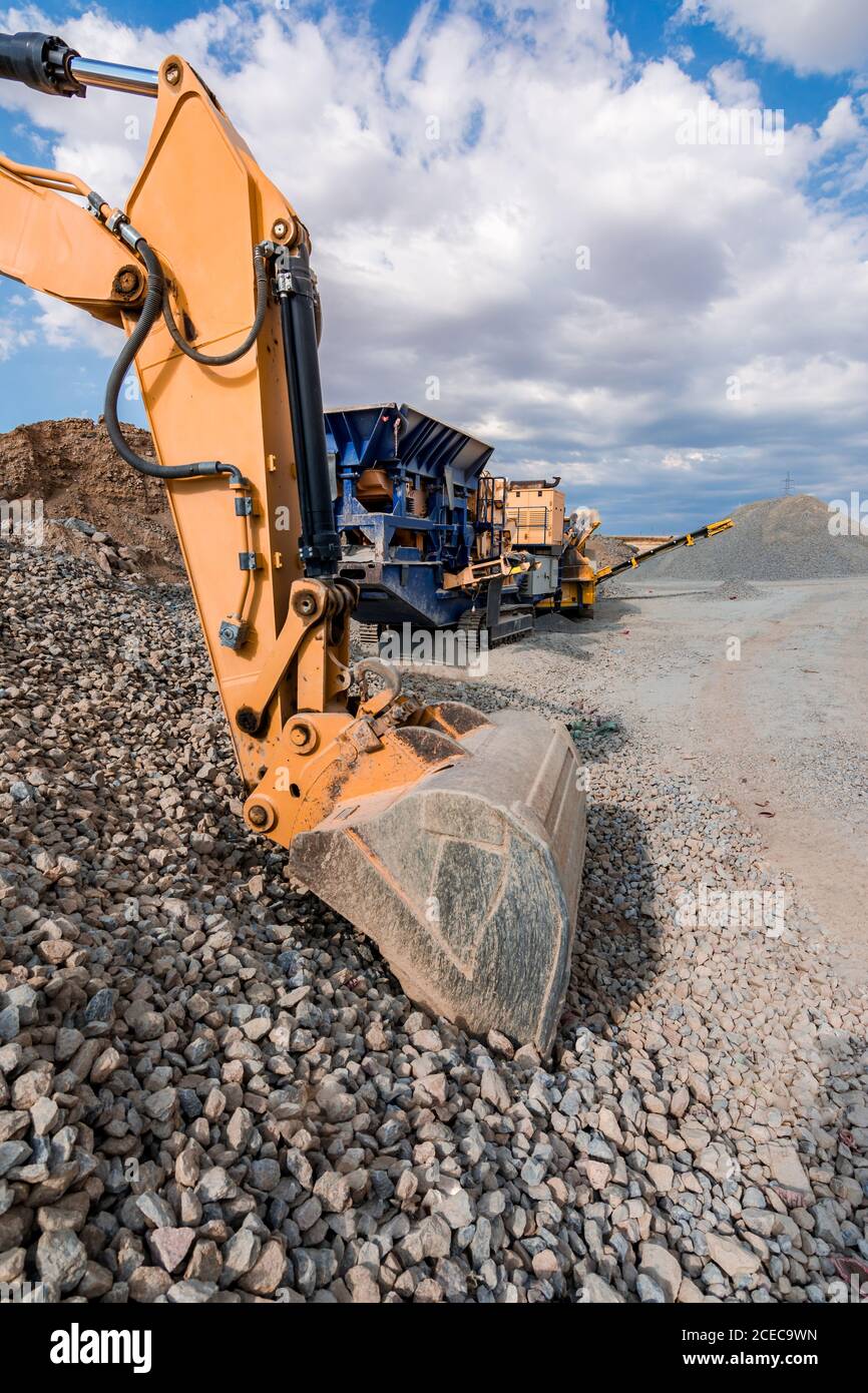 Quarry land with heavy industrial machinery Stock Photo - Alamy