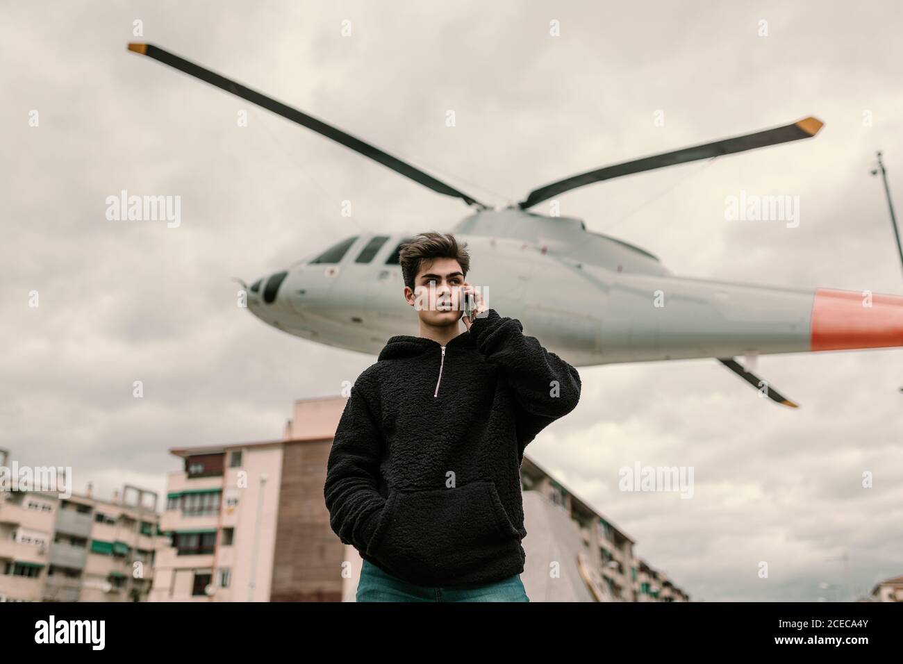 Handsome young man standing at helicopter monument on city street Stock ...