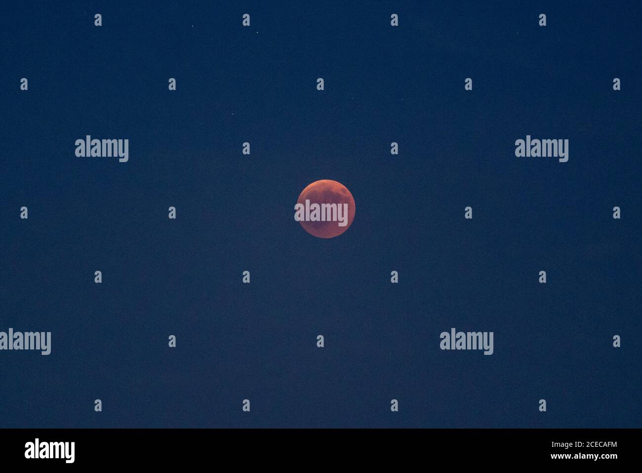 Amazing blood moon on dark night sky during eclipse in Madrid, Spain ...