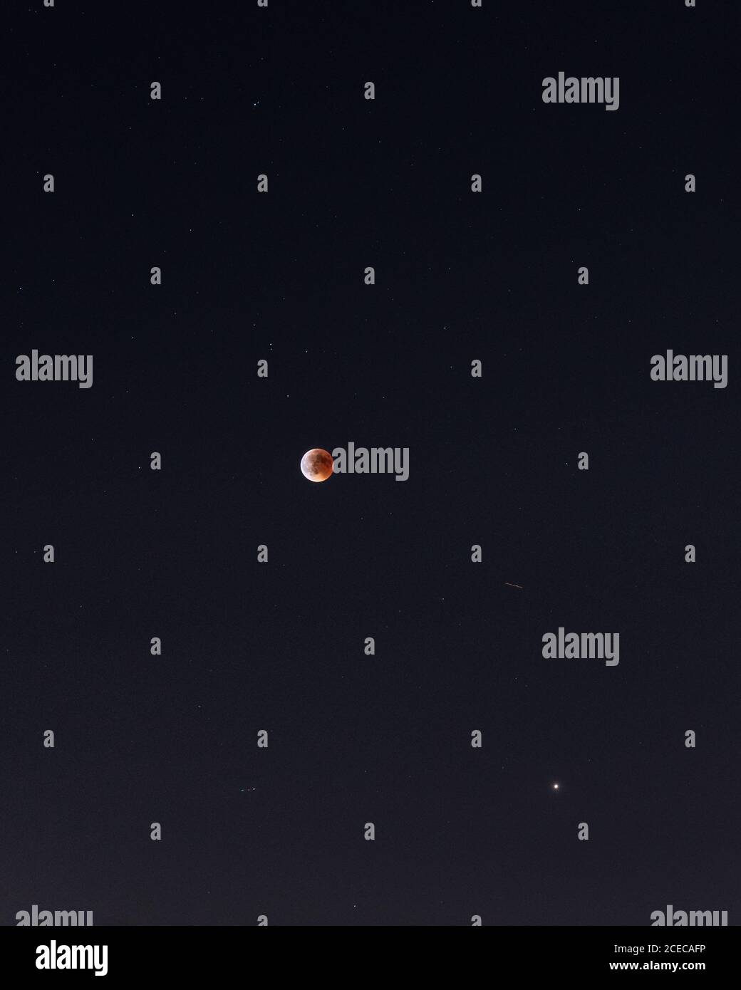 Amazing blood moon on dark night sky during eclipse in Madrid, Spain ...