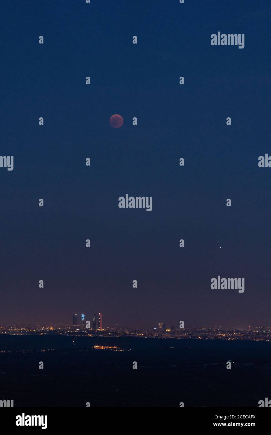Amazing blood moon on dark night sky during eclipse in Madrid, Spain ...
