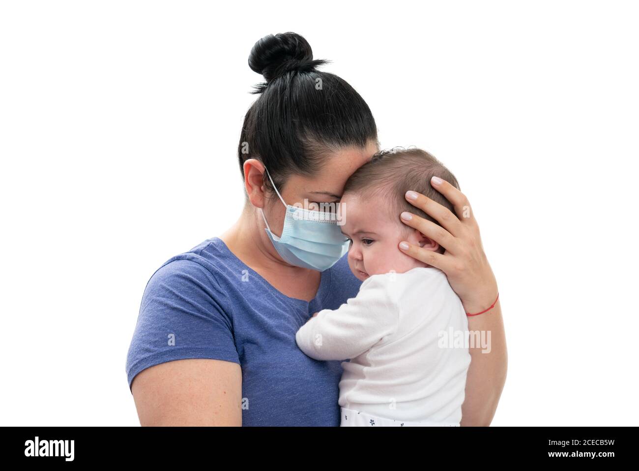 Female mother parent hugging daughter baby covering face with surgical ...
