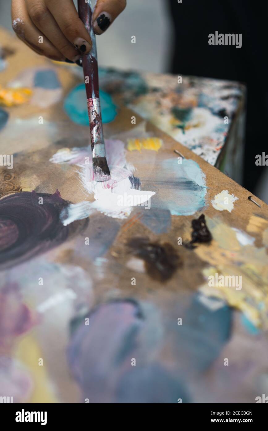 Crop artist squeezing paint Stock Photo - Alamy