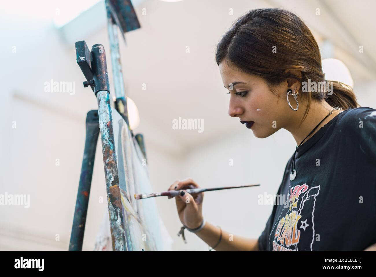 Creative Woman painting in studio Stock Photo - Alamy