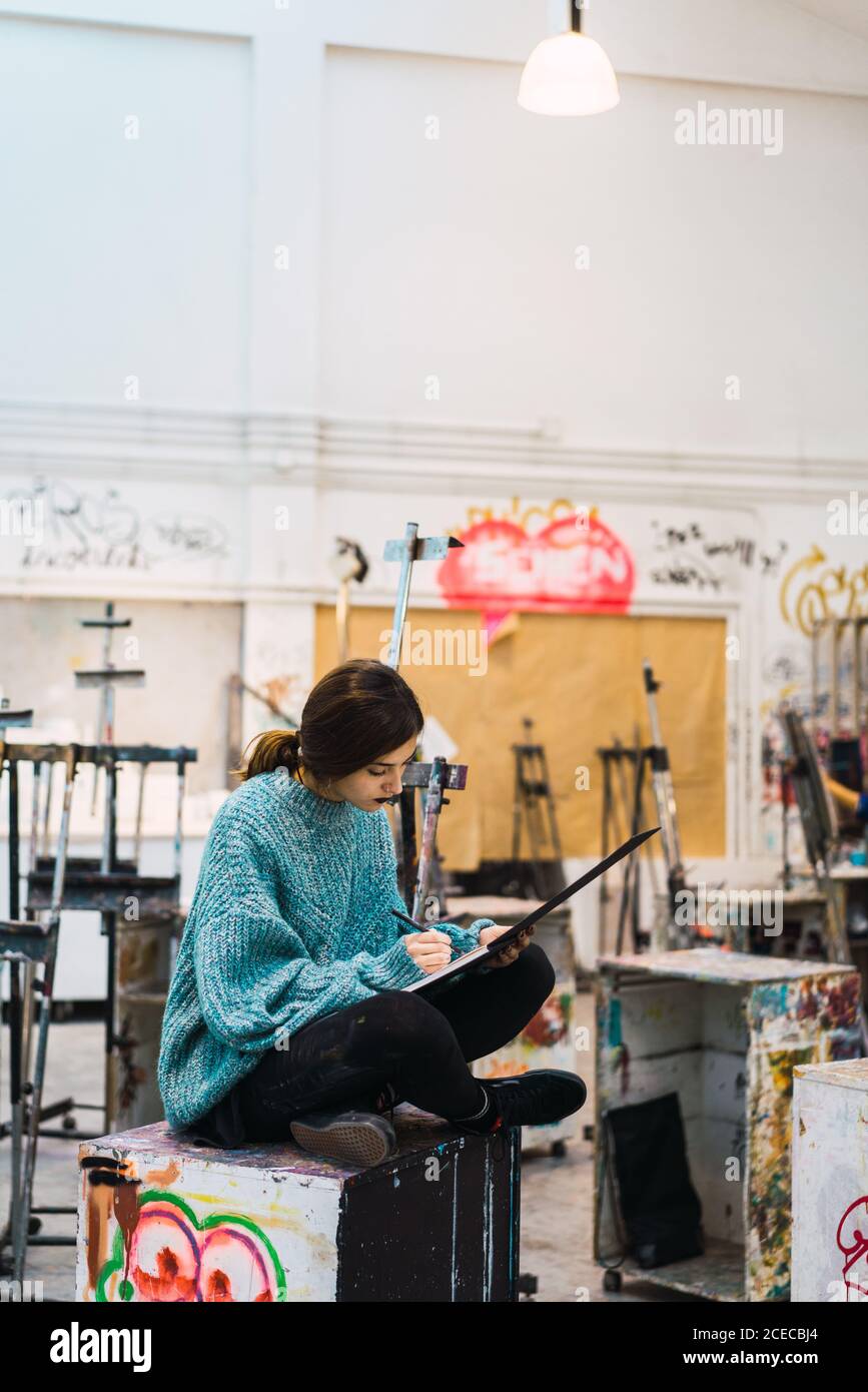 Woman creating drawing in studio Stock Photo - Alamy