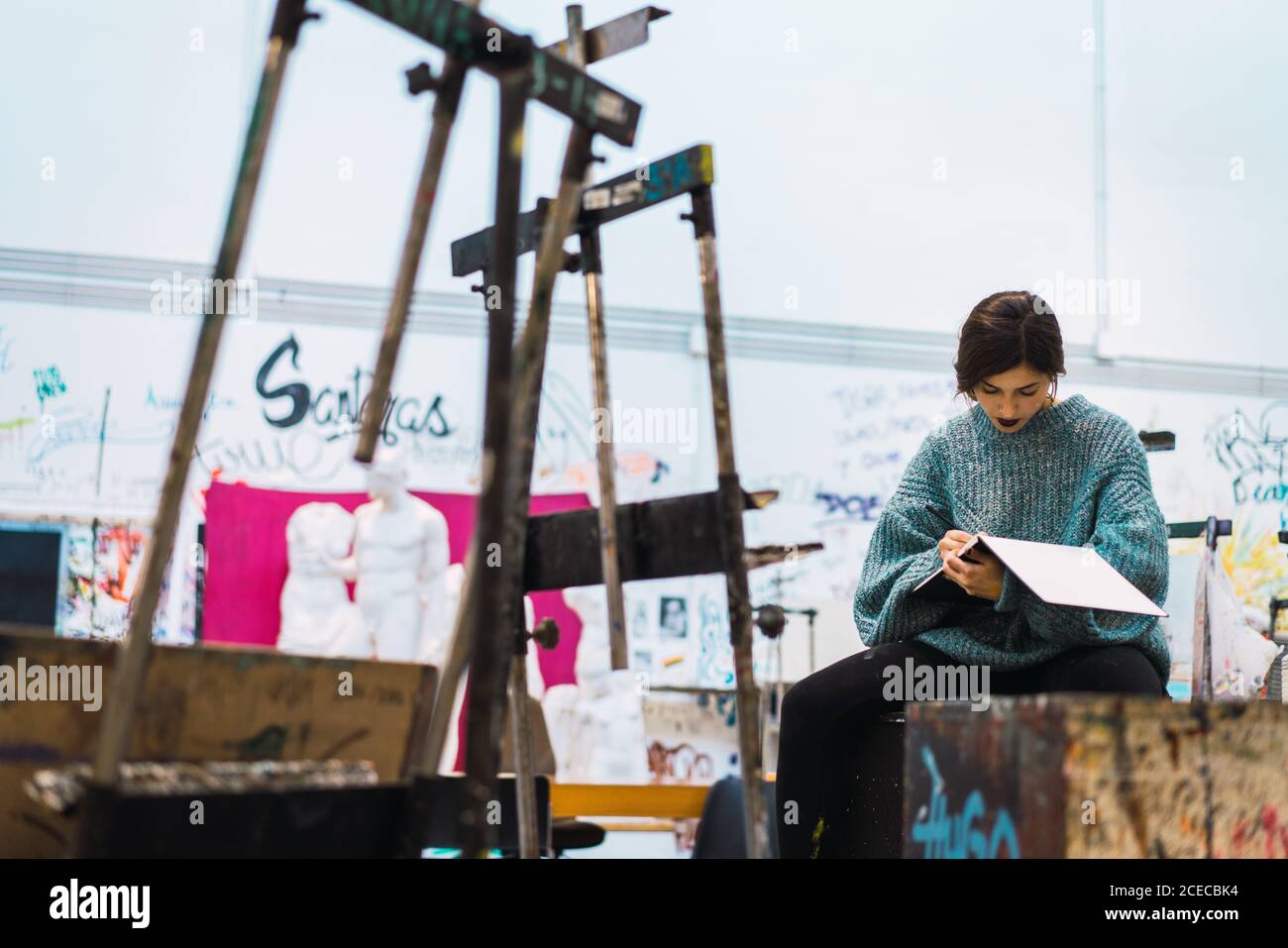 Woman creating drawing in studio Stock Photo - Alamy